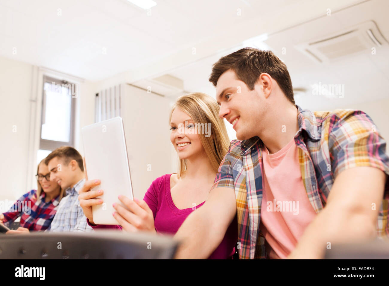 group of smiling students with tablet pc Stock Photo - Alamy