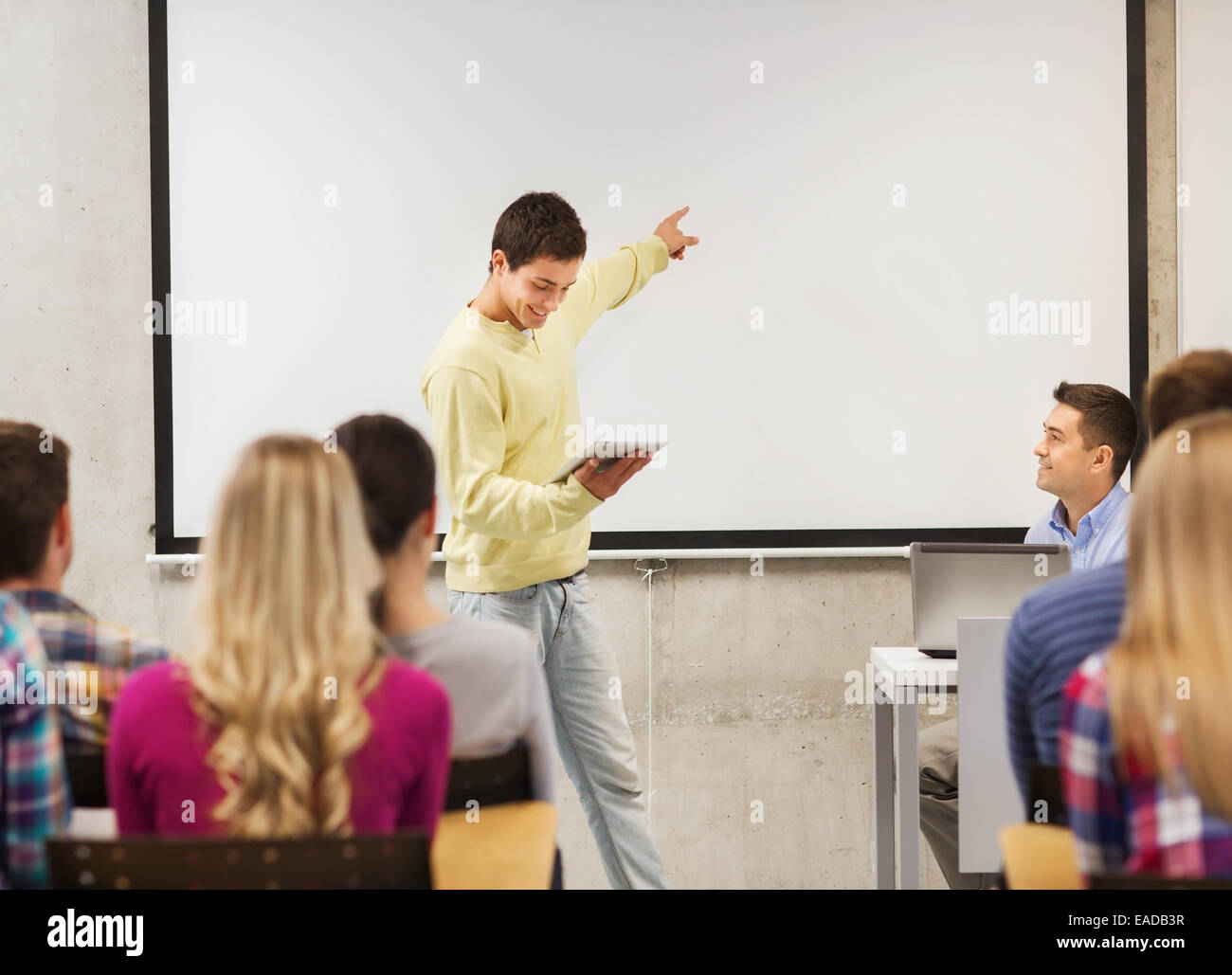group of smiling students and teacher in classroom Stock Photo - Alamy