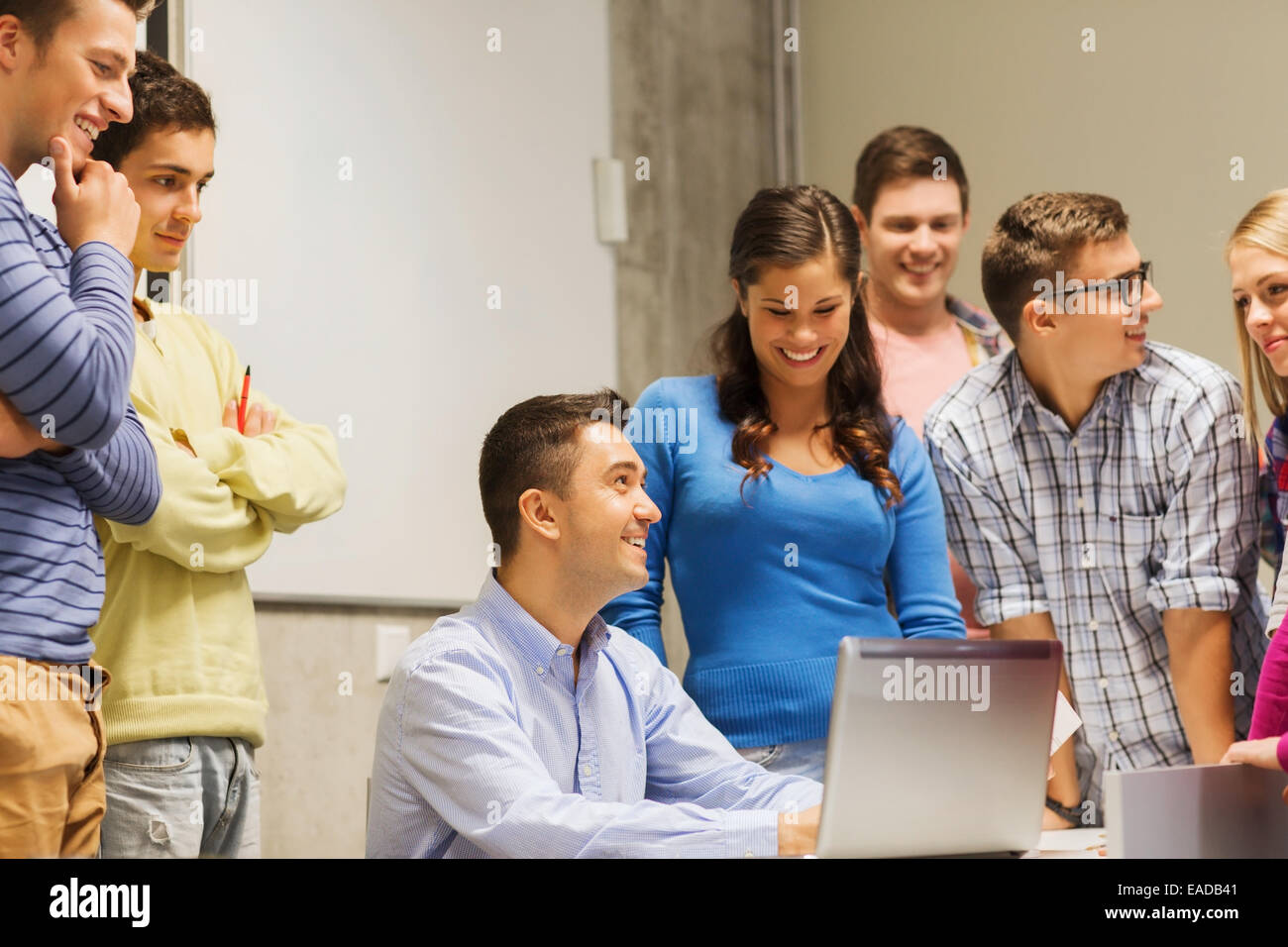 group of students and teacher with laptop Stock Photo - Alamy
