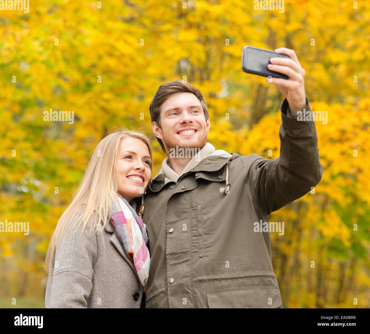 smiling couple hugging in autumn park Stock Photo - Alamy