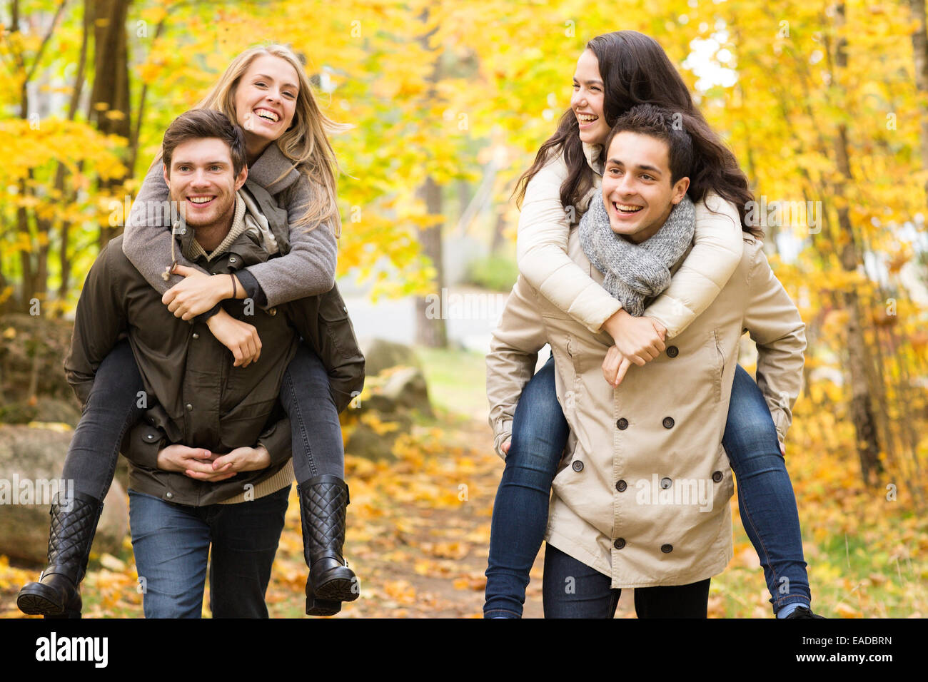 smiling friends having fun in autumn park Stock Photo - Alamy