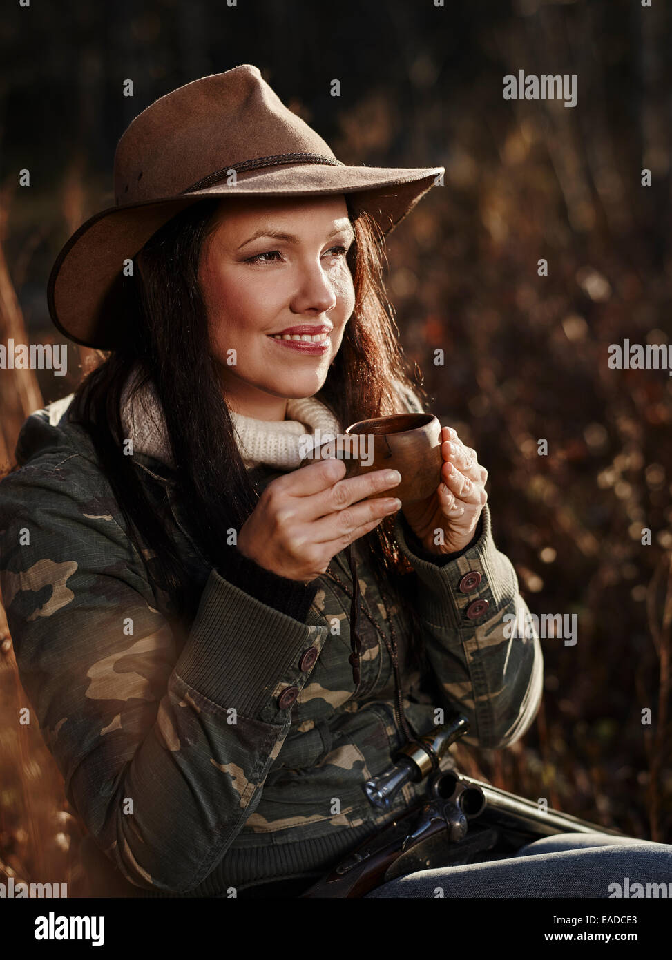 Waterfowl hunting, the female hunter having a coffee break, autumnal ...