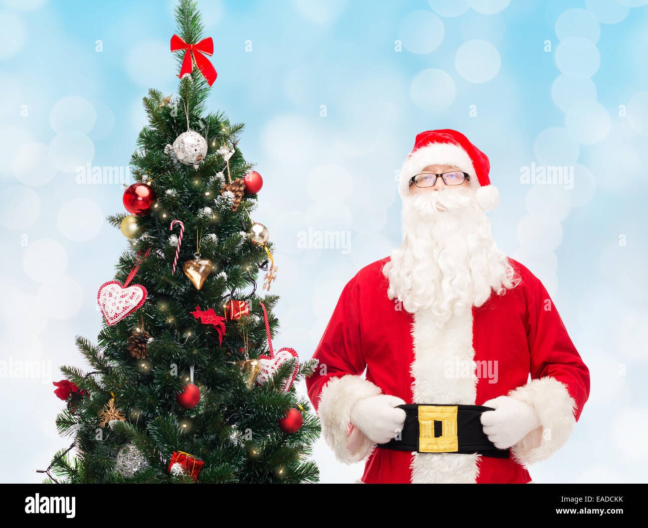 man in costume of santa claus with christmas tree Stock Photo - Alamy
