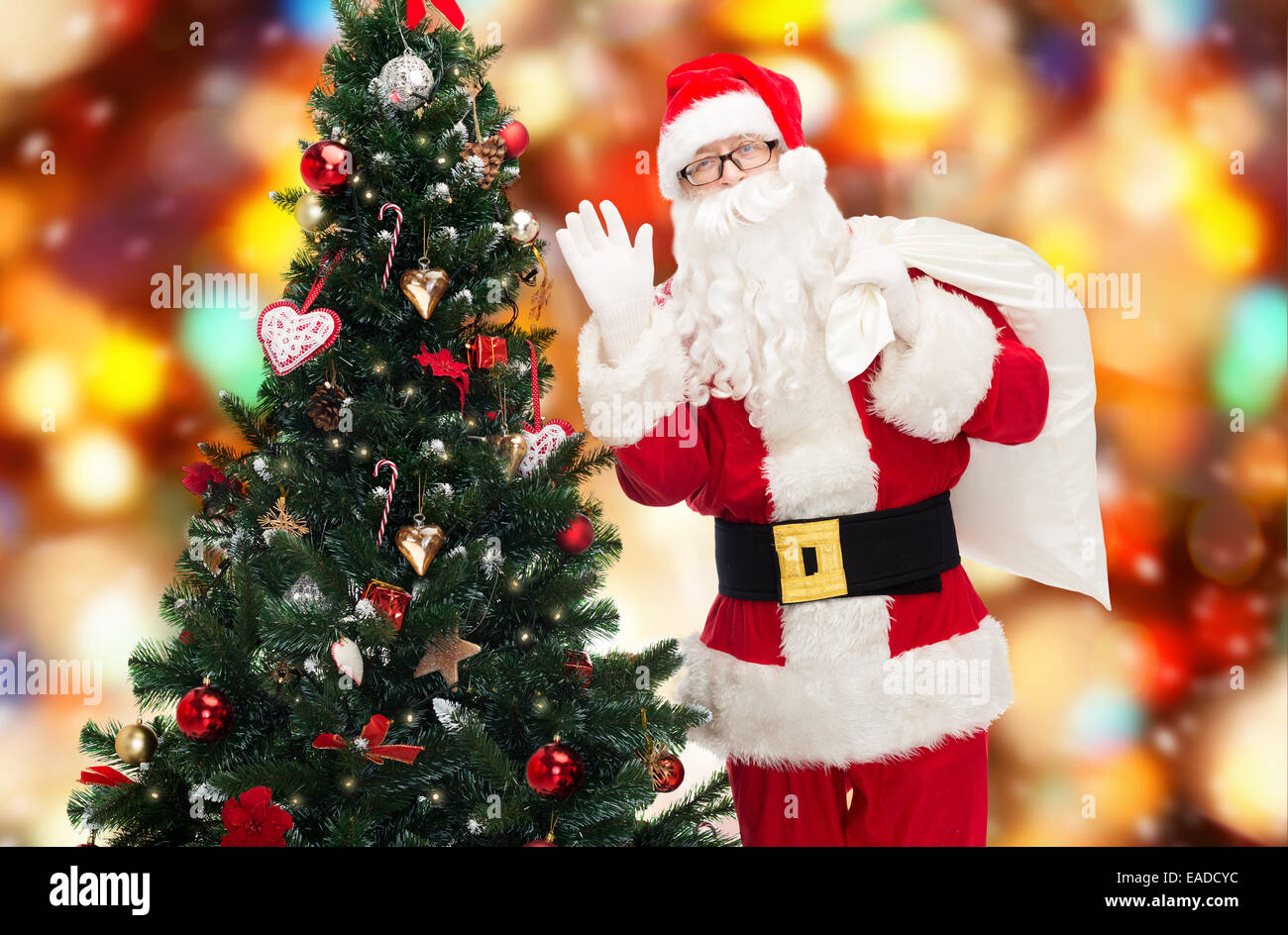 santa claus with bag and christmas tree Stock Photo - Alamy