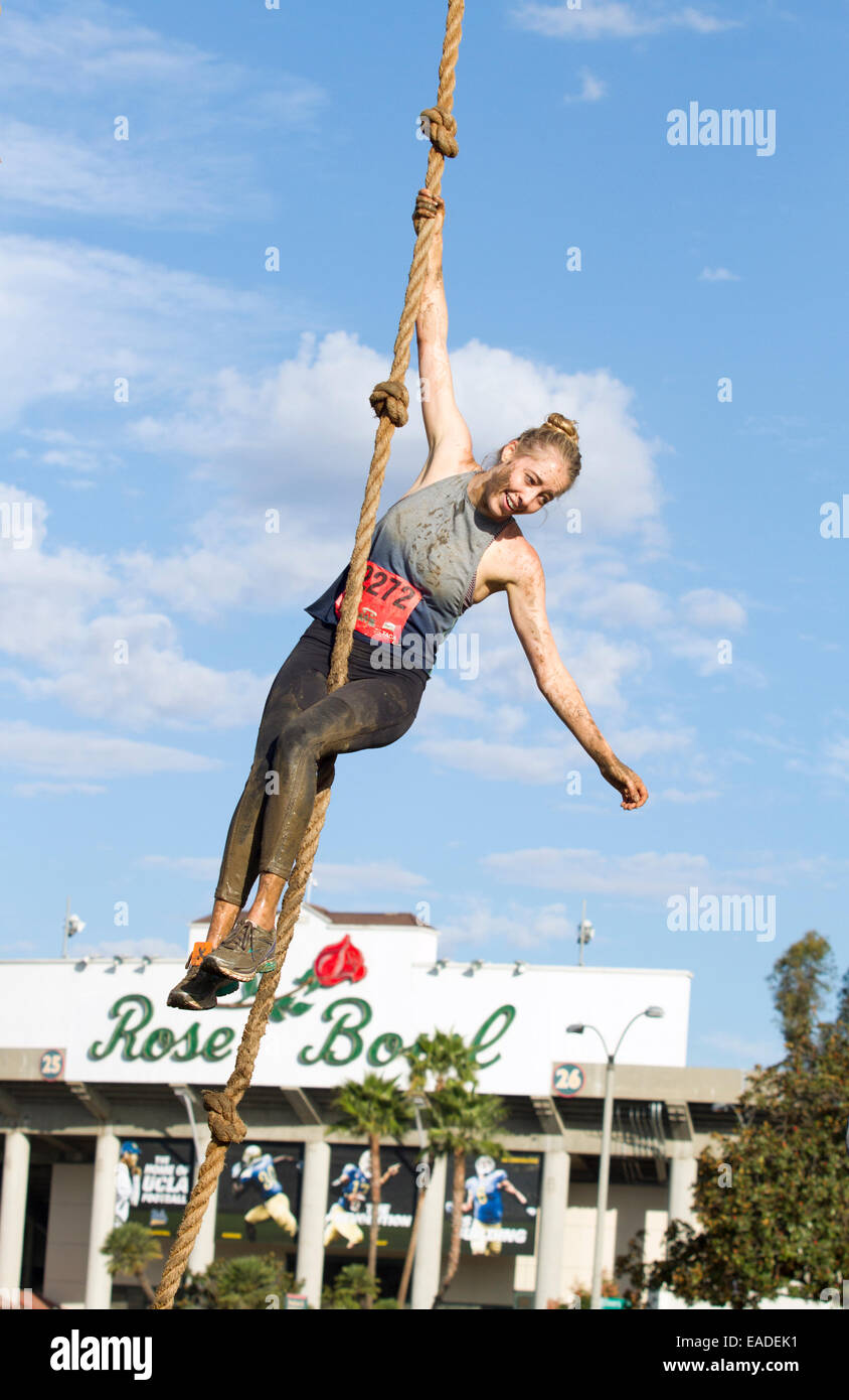 Female athlete competing in the "Ring the Bell" rope climb at the ...