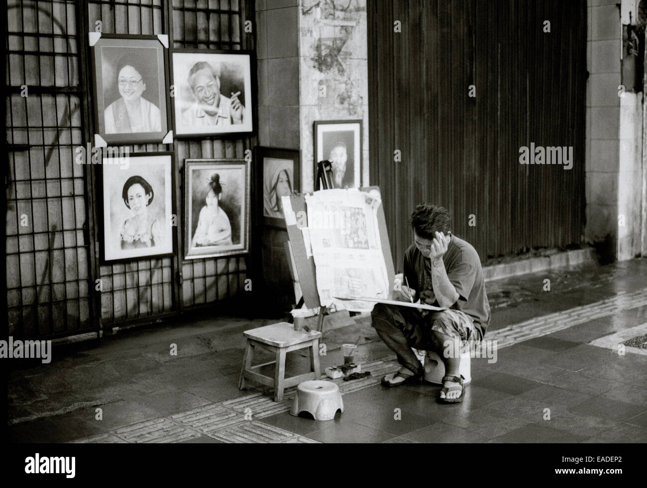 Street artist working in the city of Jakarta in Java in Indonesia in ...