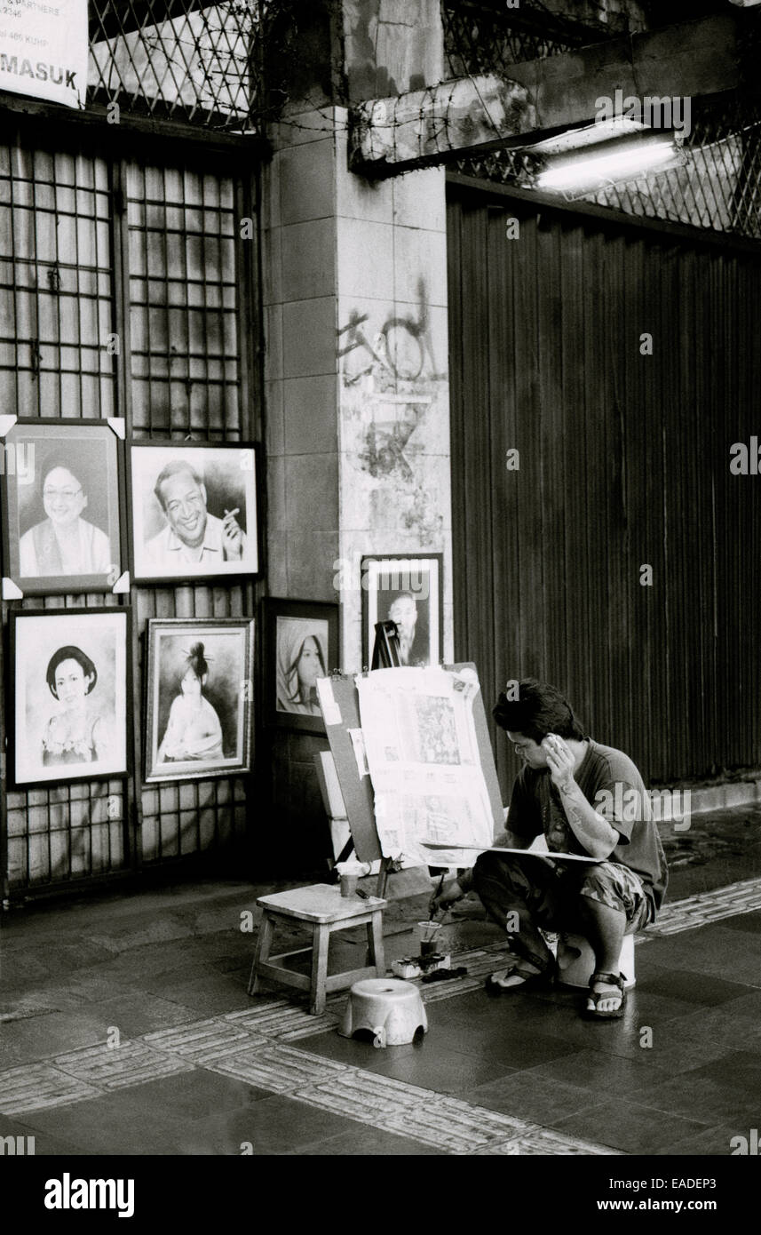 Street artist working in the city of Jakarta in Java in Indonesia in ...