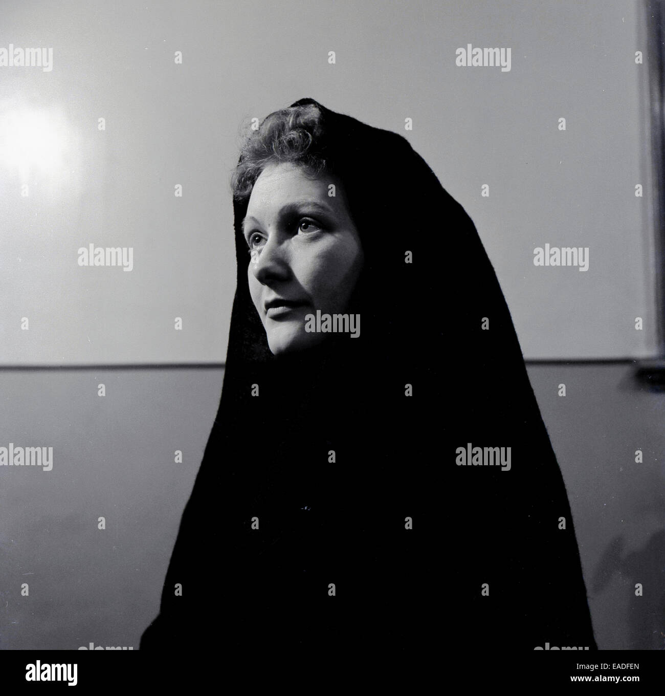 1950s historical picture of a catholic lady wearing a black headscarf ...