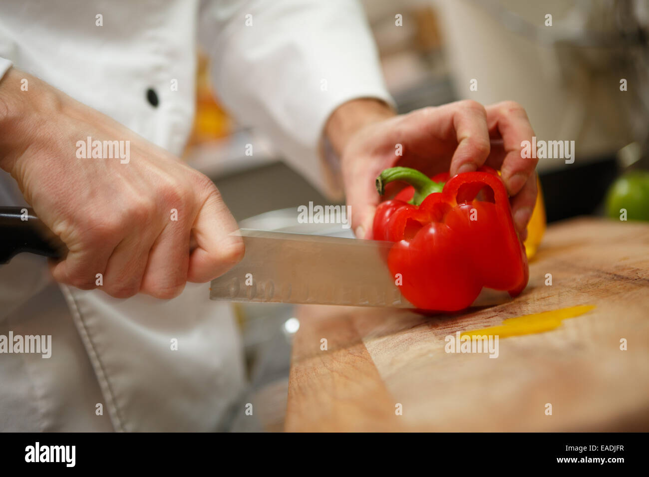 closeup on hands cutting yellow pepper Stock Photo - Alamy