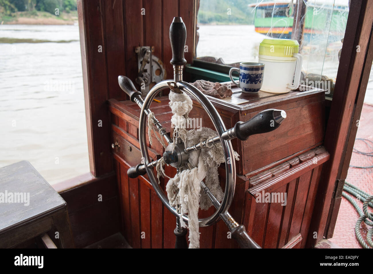 Steering wheel on a two day cruise on a slow ferry boat along Mekong ...