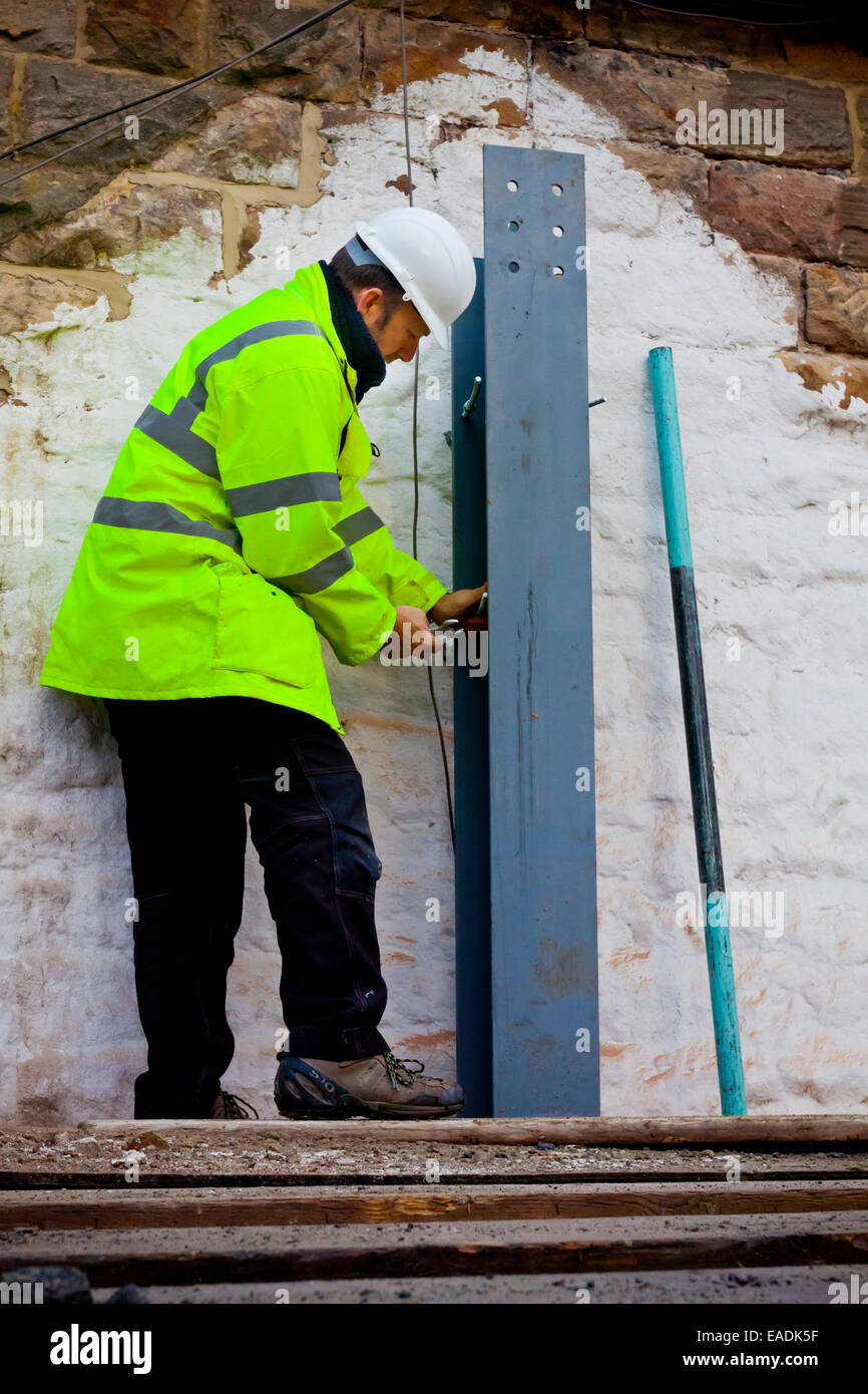 Builder working on a construction site wearing a high visibility jacket ...