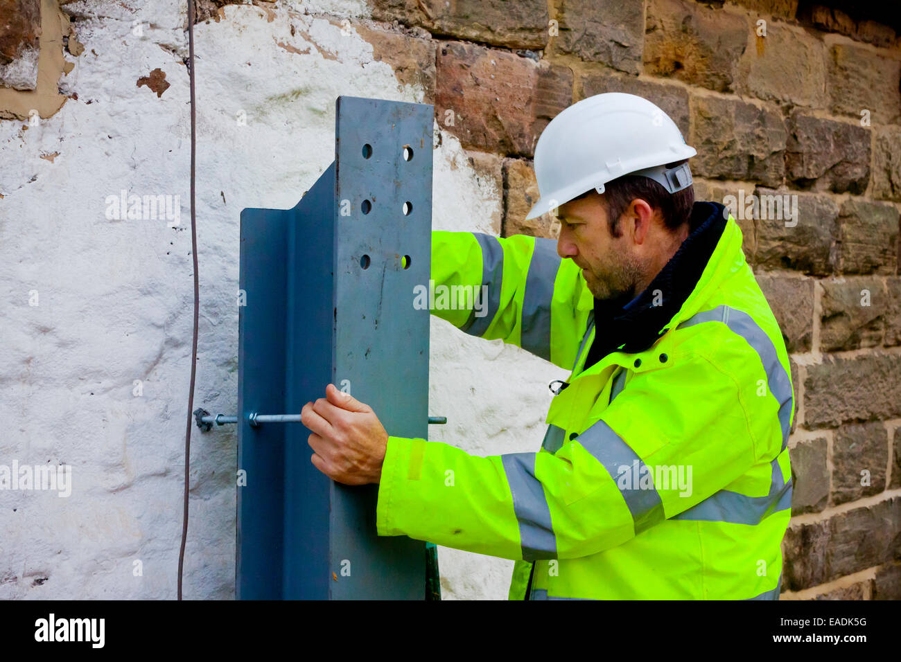 Builder working on a construction site wearing a high visibility jacket ...