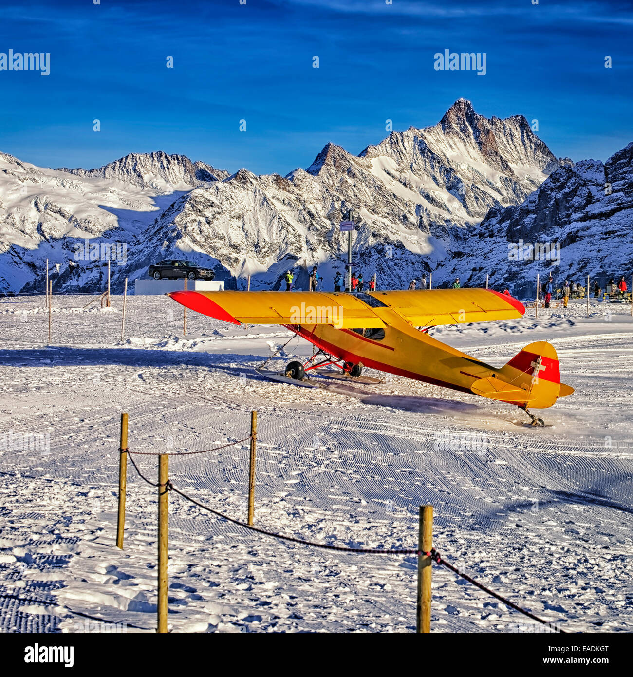 Yellow red airplane at the mountain ski resort airfield in swiss alps ...
