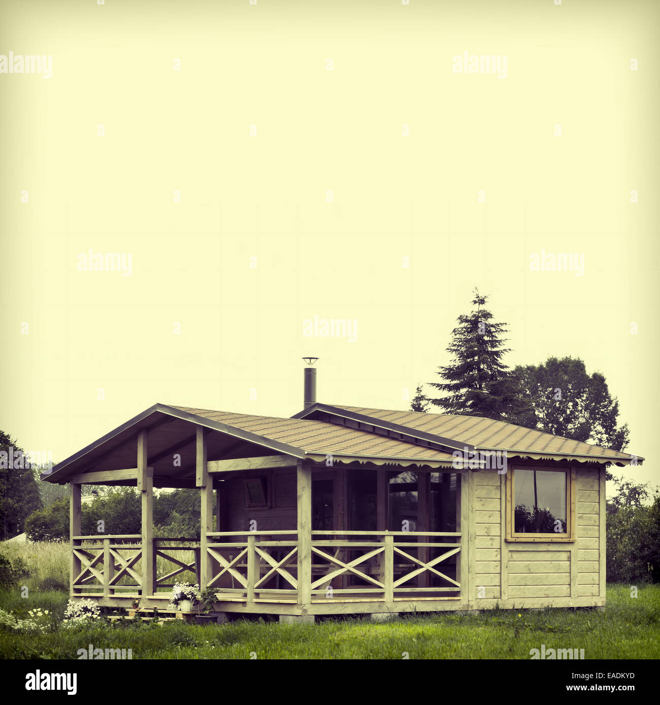 Summer lodge. Small wooden cabin with a terrace outdoors. To a photo ...