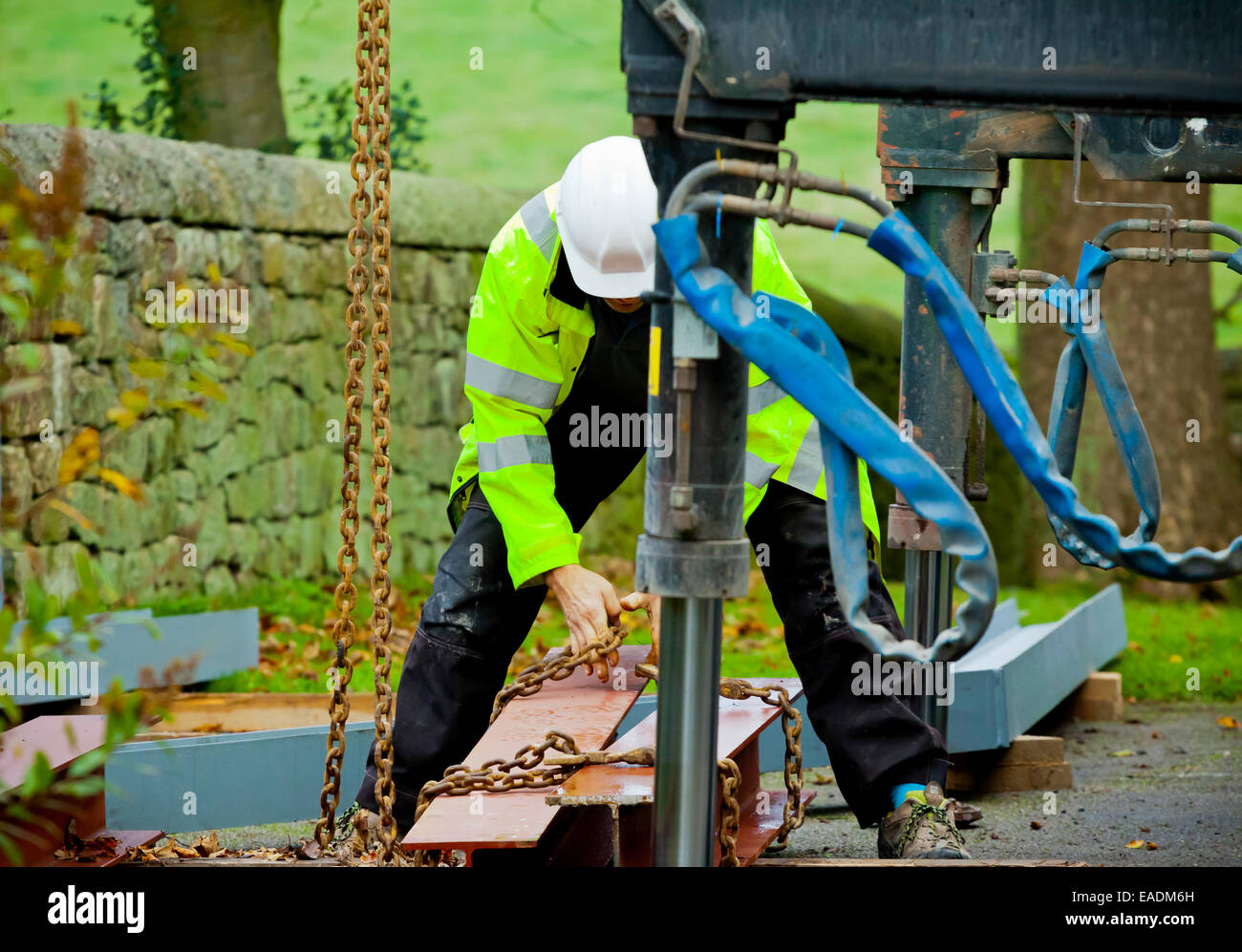 Builder working on a construction site wearing a high visibility jacket ...