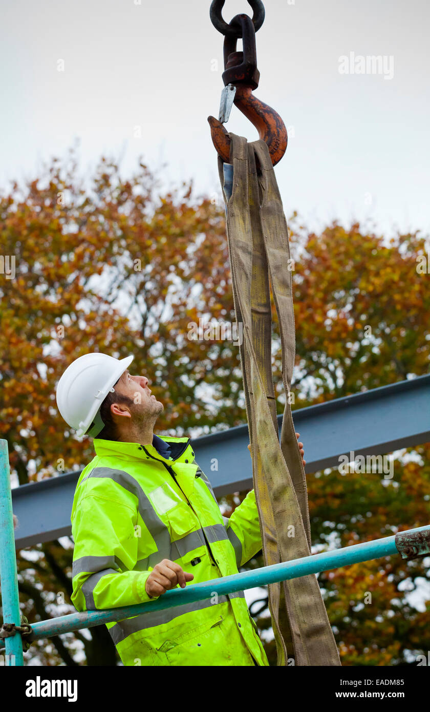 Builder working on a construction site wearing a high visibility jacket ...