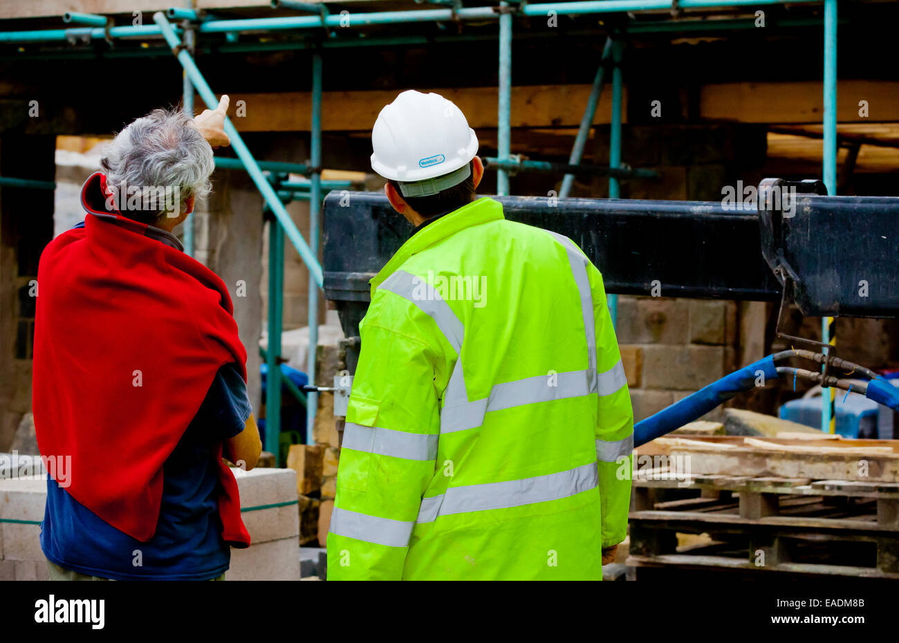 Builder and architect working on a construction site wearing a high ...