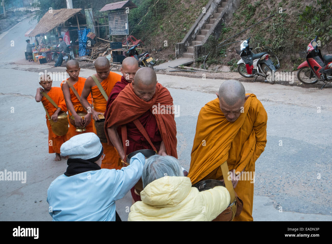 Buddhist monks very early alms walk with begging bowls to receive ...