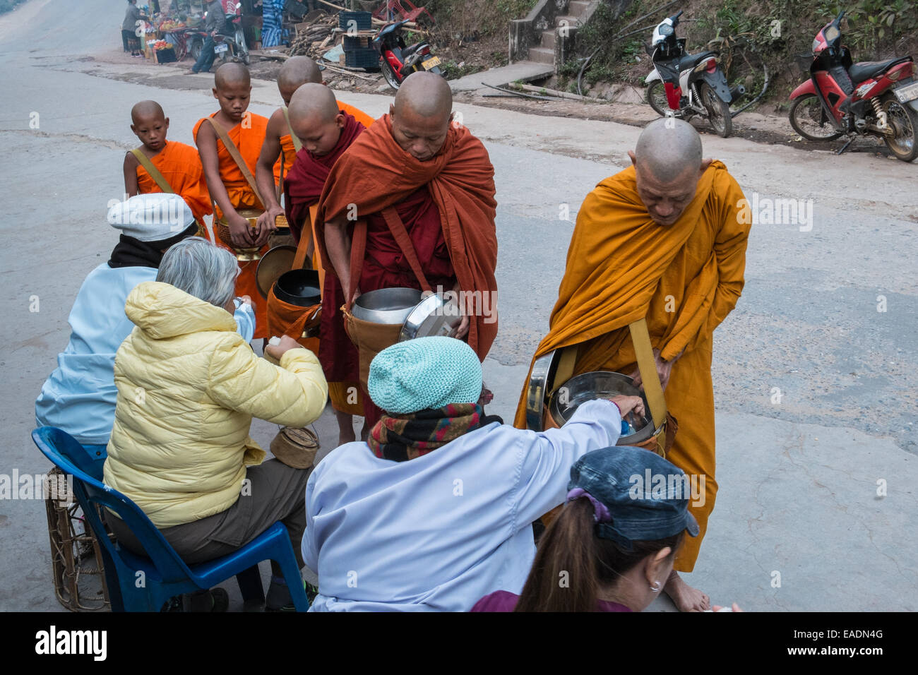 Buddhist monks very early alms walk with begging bowls to receive ...
