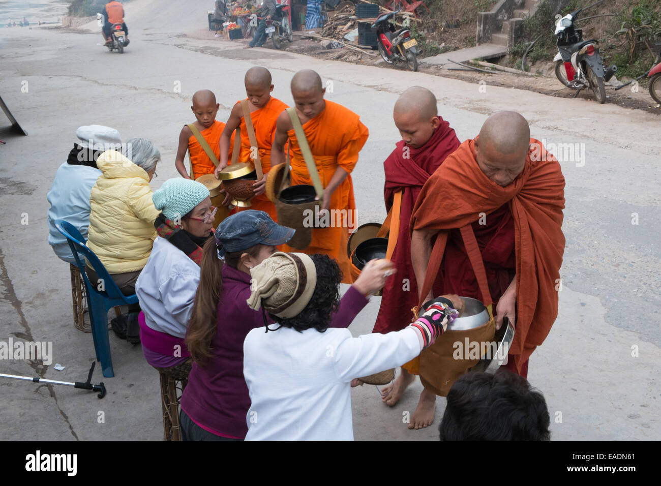 Buddhist monks very early alms walk with begging bowls to receive ...