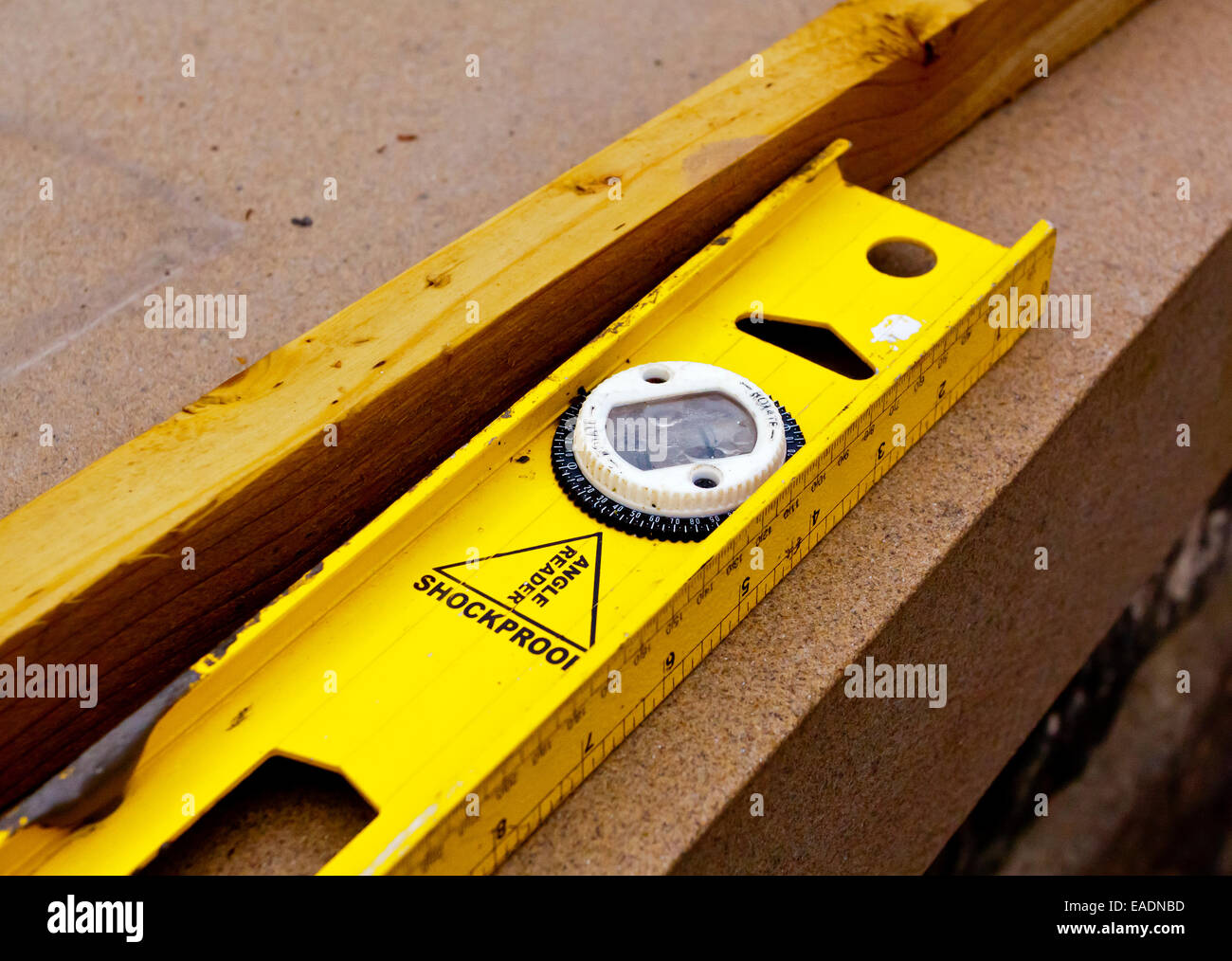 Yellow spirit level on a building site used to measure accuracy of ...