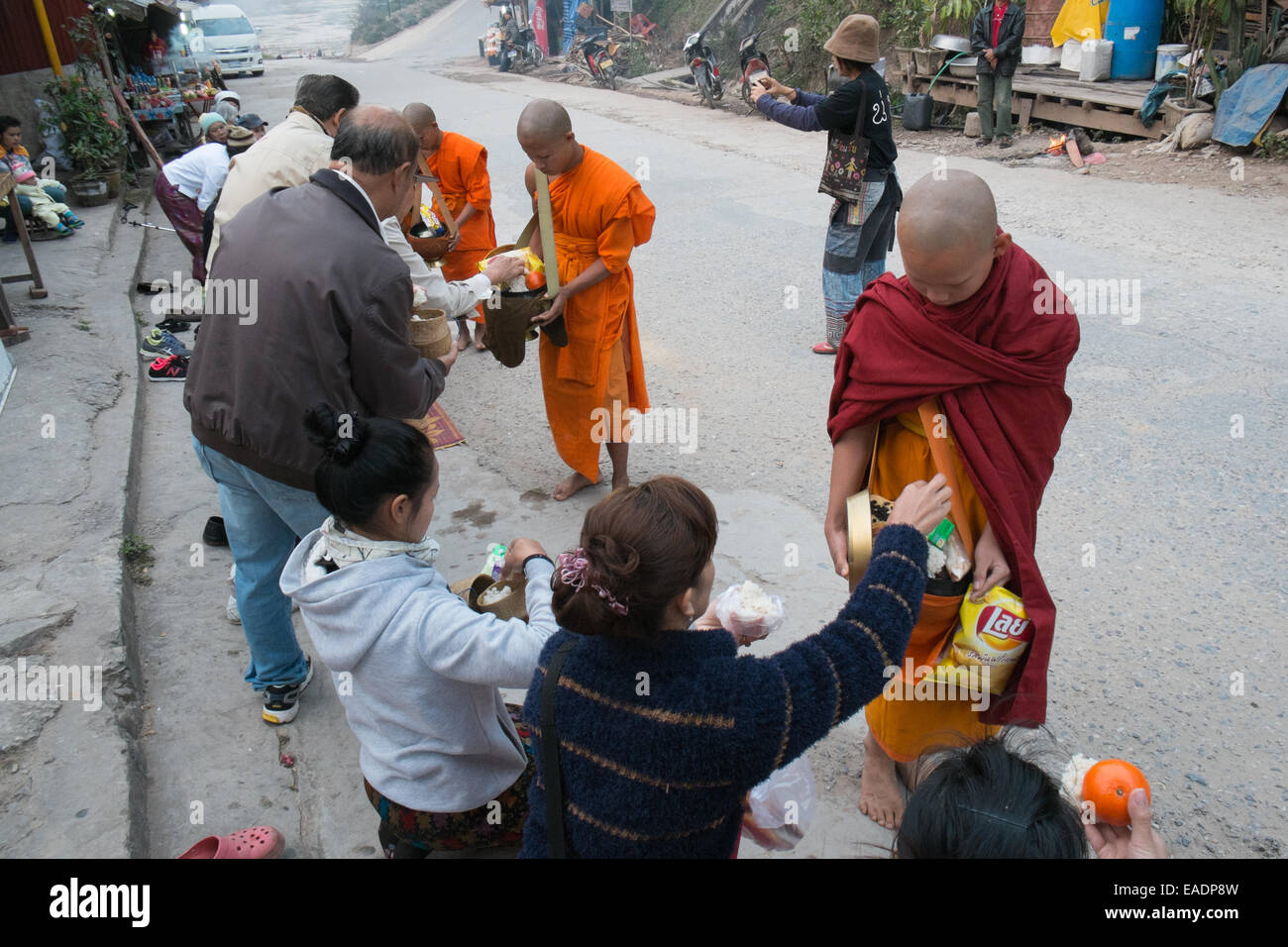 Buddhist monks very early alms walk with begging bowls to receive ...