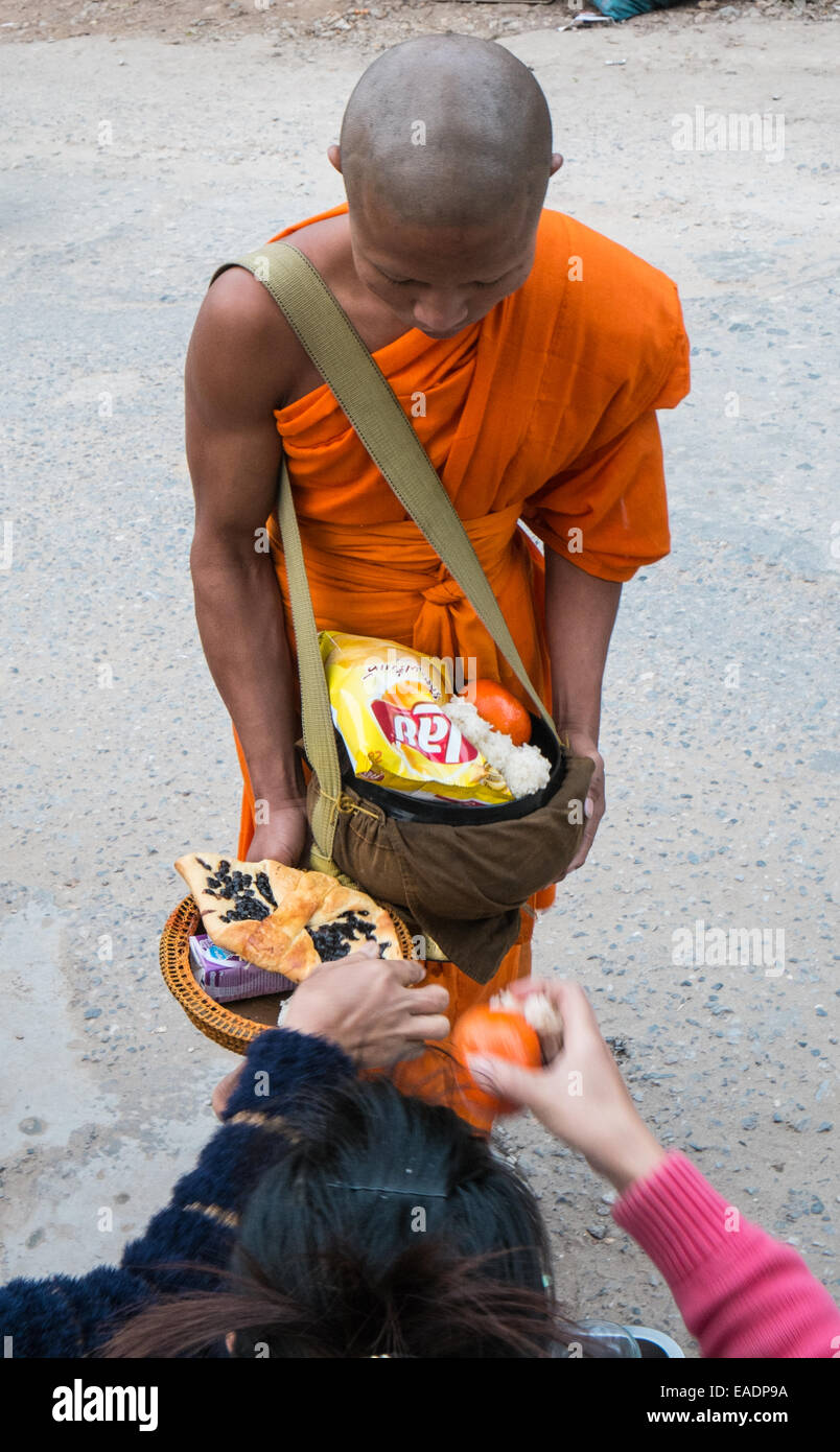 Buddhist monks very early alms walk with begging bowls to receive ...