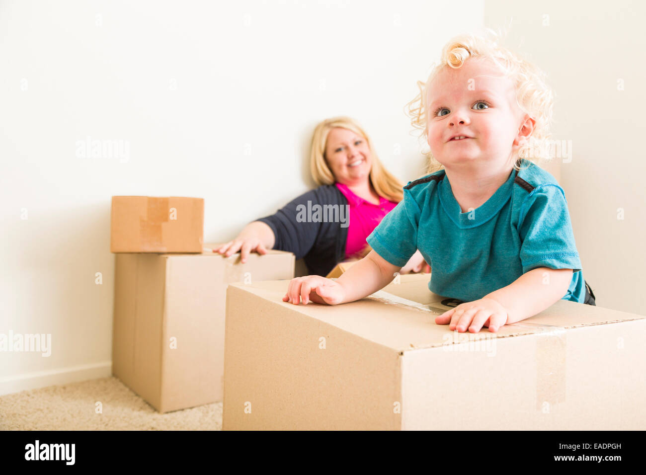 Playful Happy Mother and Son in Empty Room with Moving Boxes Stock ...