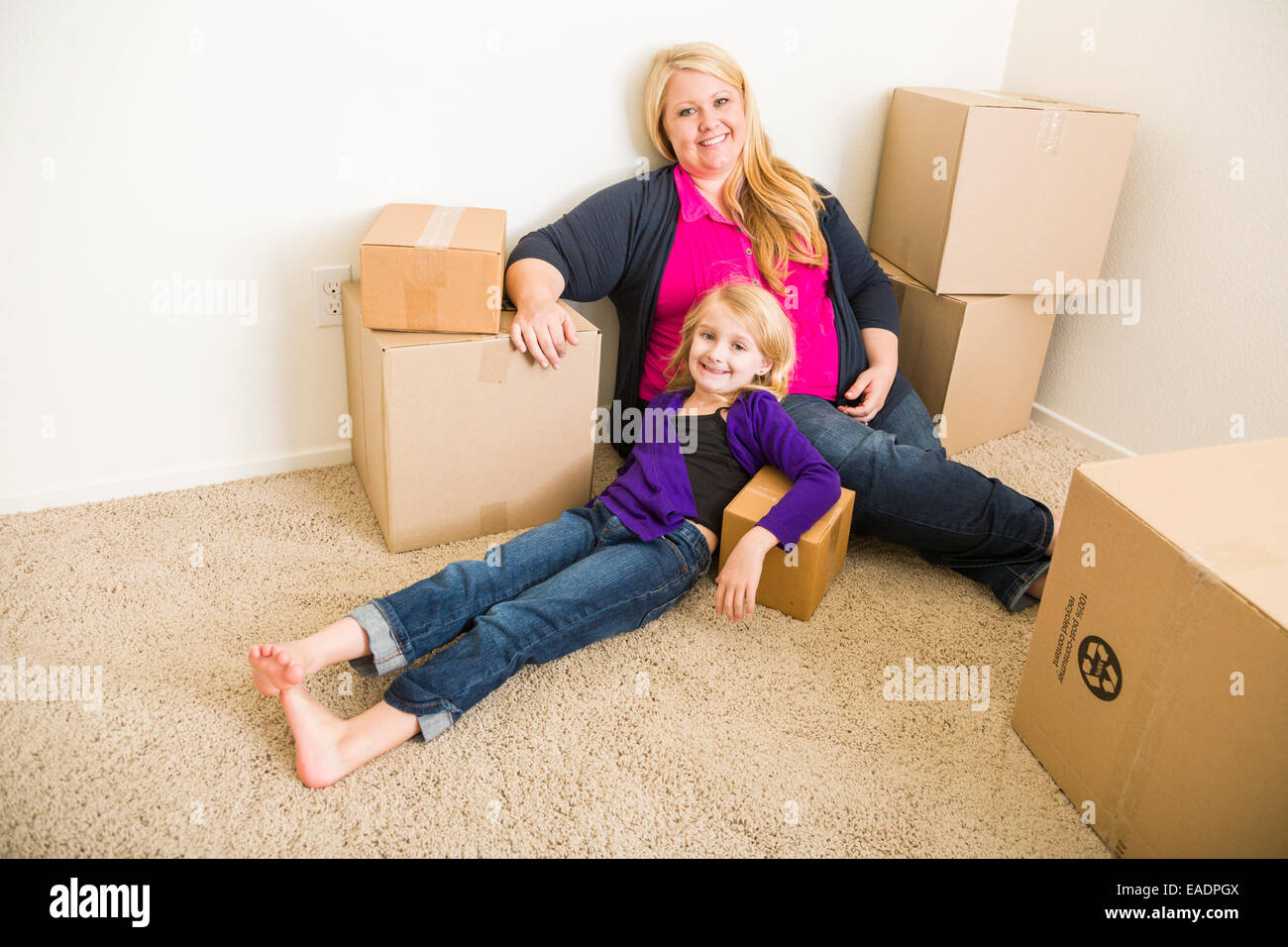 Happy Young Mother and Daughter In Empty Room With Moving Boxes Stock ...