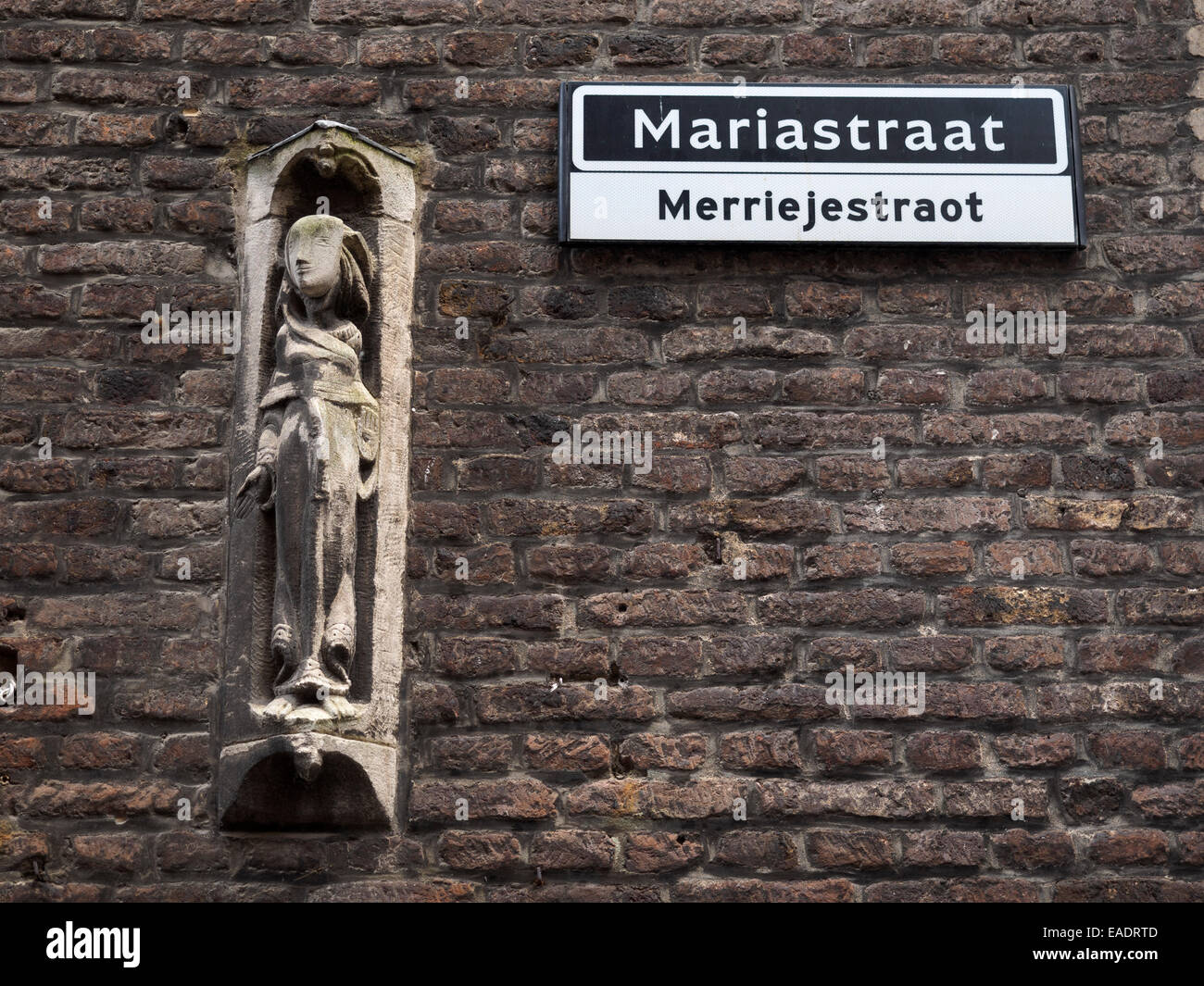 Statue next to the Mariastraat sign in Maastricht, The Netherlands ...