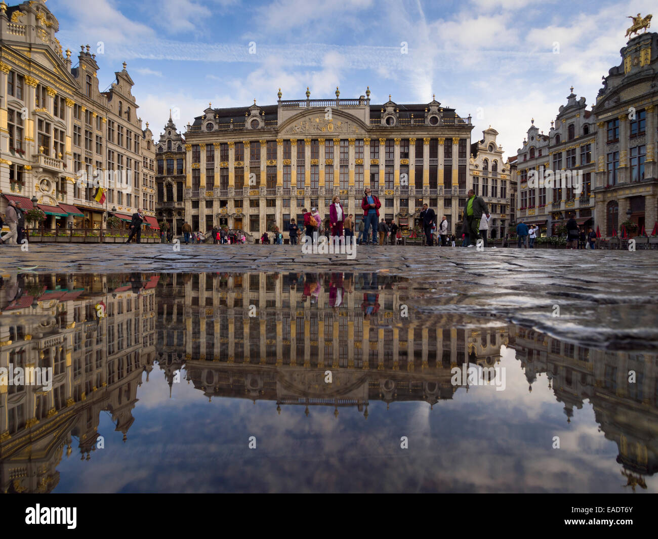 Ornate buildings of the Grand Place in Brussels reflected on a water ...