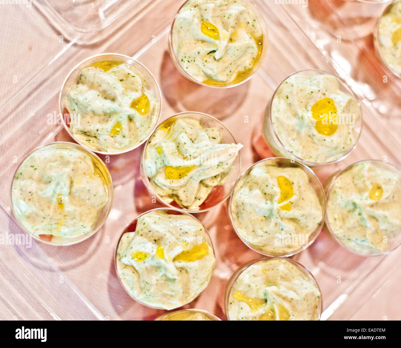 Mousse appetizer arugula, ricotta and cream on a bed of red cherry ...