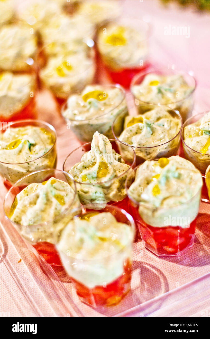 Mousse appetizer arugula, ricotta and cream on a bed of red cherry ...