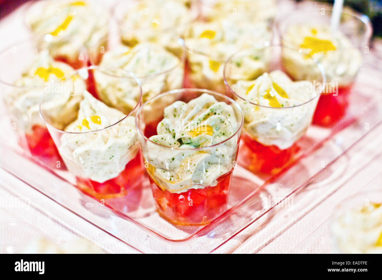 Mousse appetizer arugula, ricotta and cream on a bed of red cherry ...