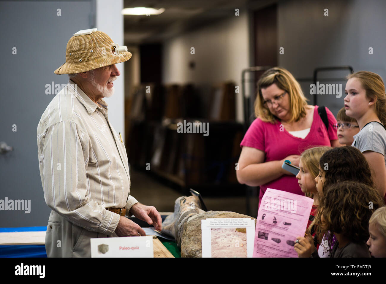 Paleontologist talking about fossil bones with school kids and their ...