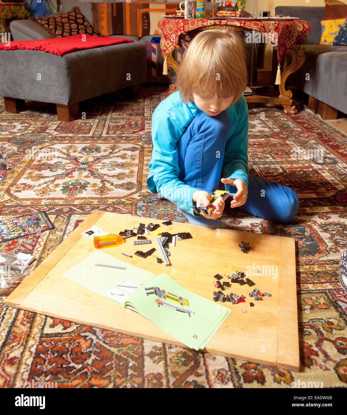 Boy Putting Together his Assembling Toys on the Floor Stock Photo - Alamy