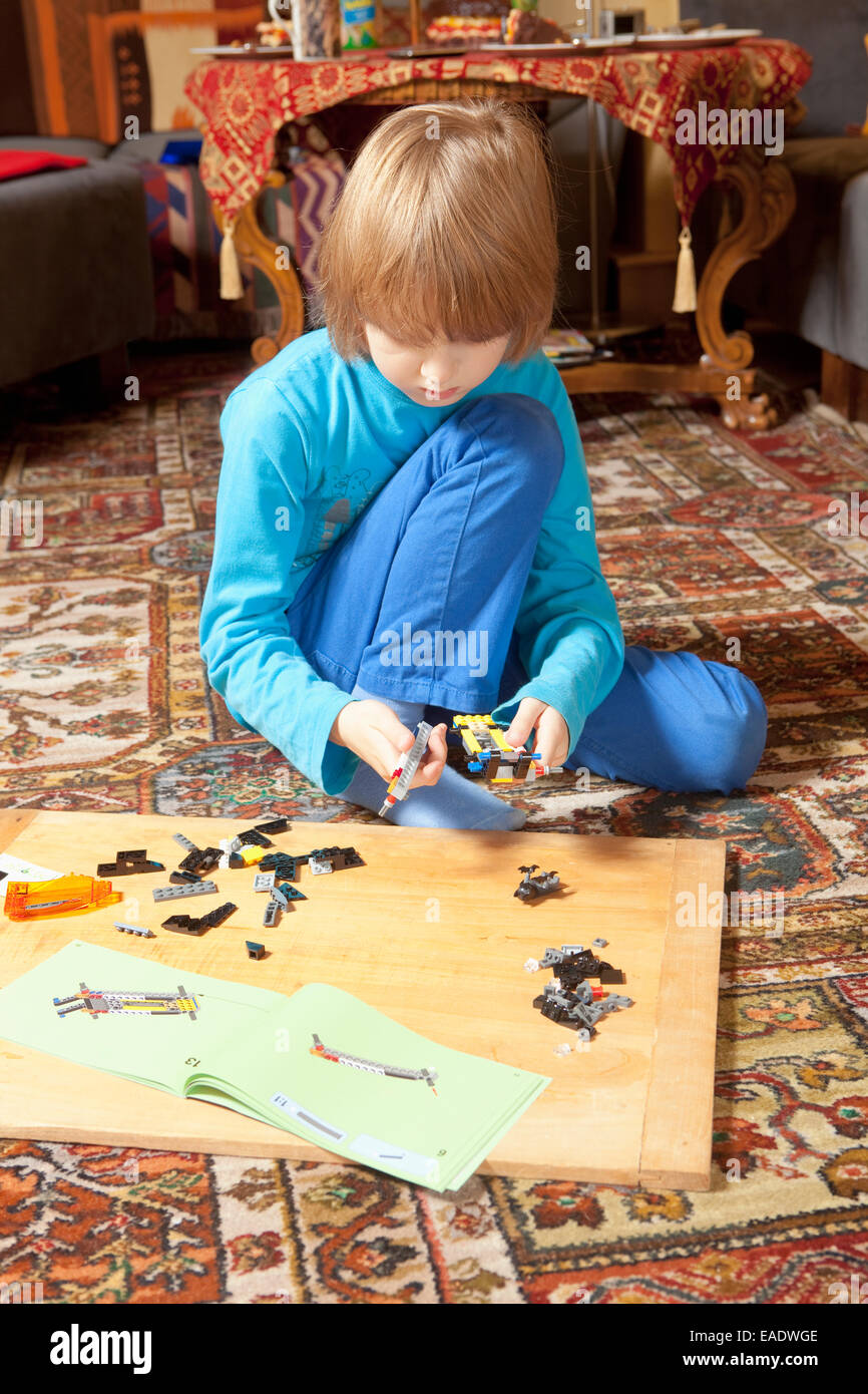 Boy Putting Together his Assembling Toys on the Floor Stock Photo - Alamy