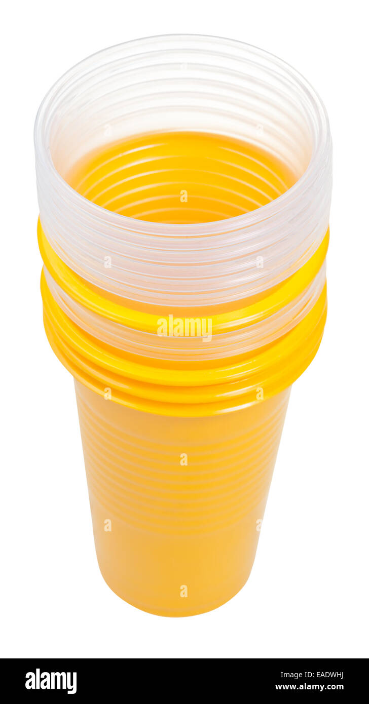 disposable dishes - stack of yellow and transparent plastic glasses ...