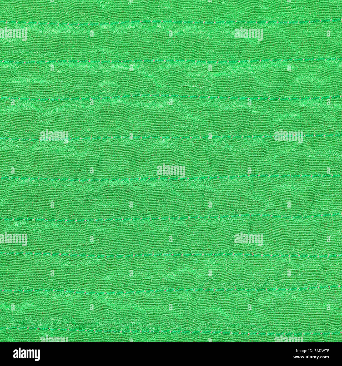 green color textile background from stitched silk fabric close up Stock ...