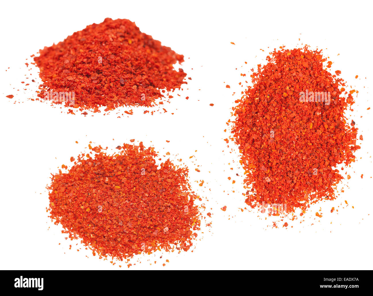 three piles of ground red chili pepper - paprika isolated on white ...