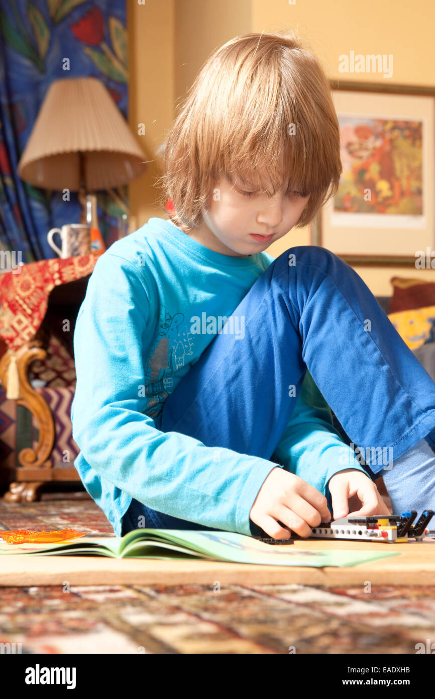 Boy Putting Together his Assembling Toys on the Floor Stock Photo - Alamy