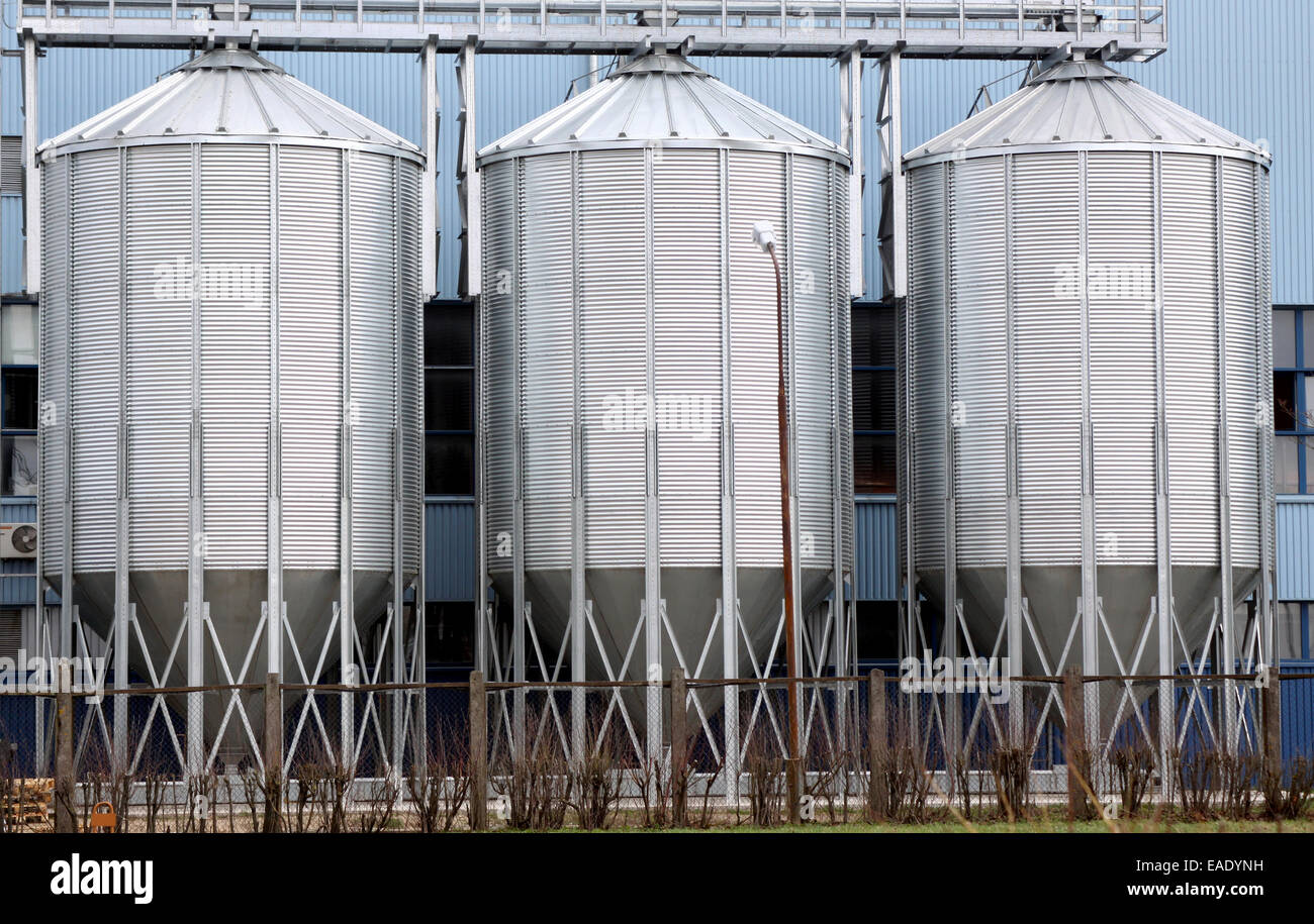 Three shiny steel storage tanks, industrial background Stock Photo - Alamy