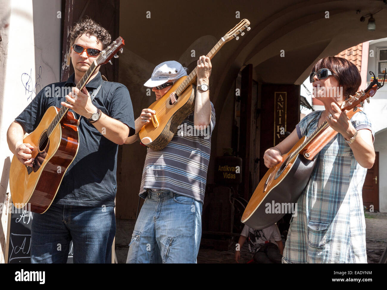 Three street musicians performing at traditional street musicians ...