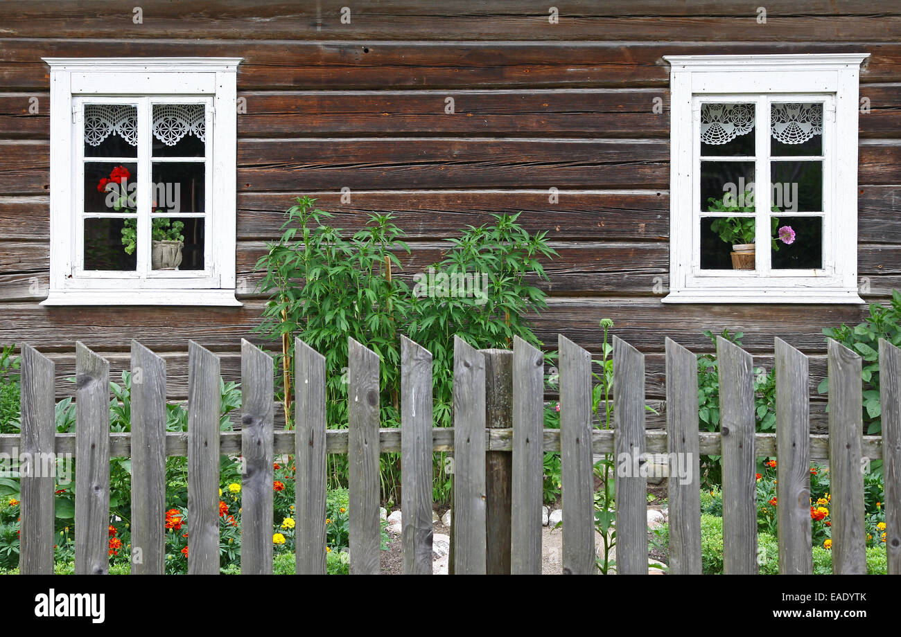 Picture of an old rural house with two windows and wooden fence Stock ...