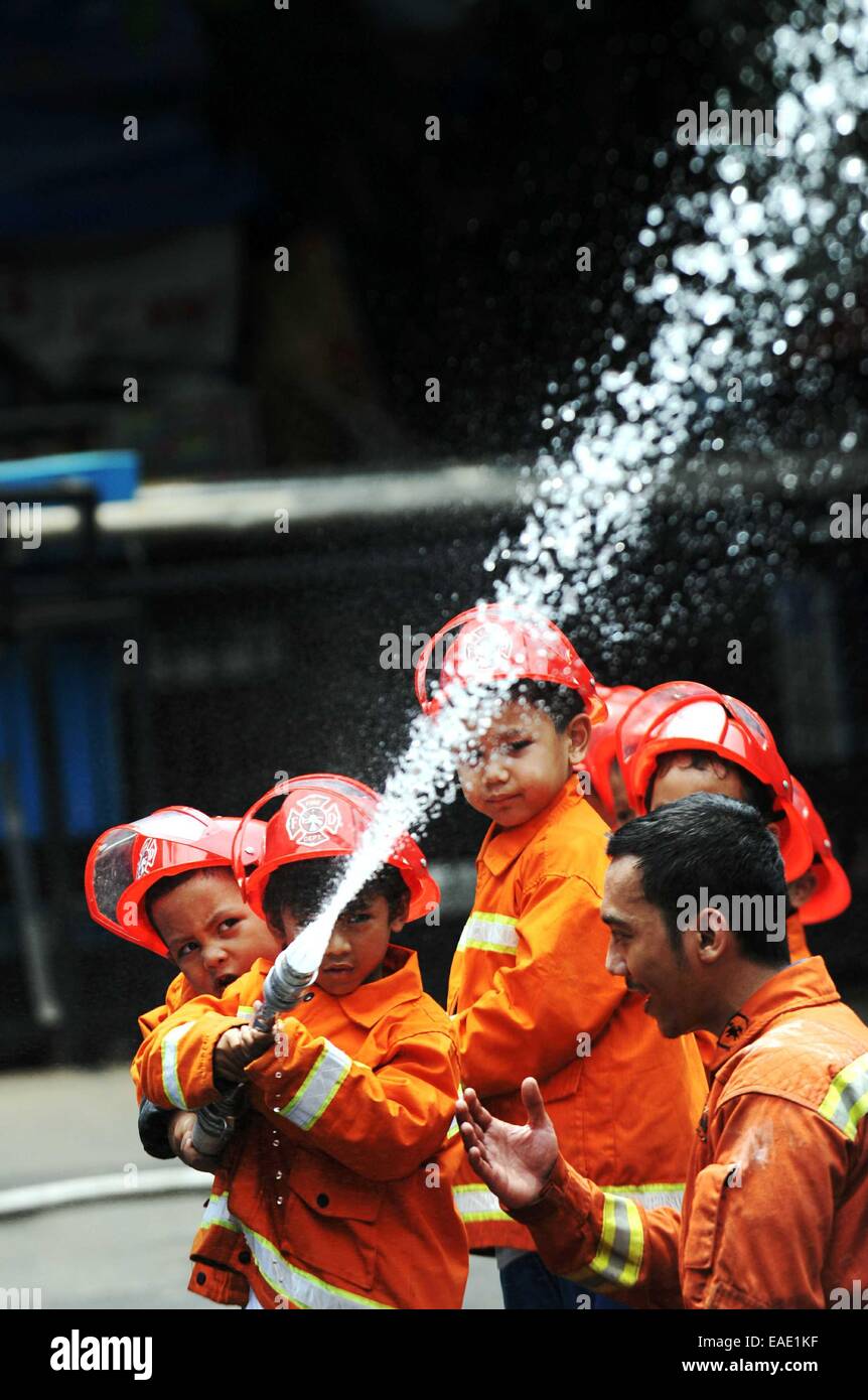 Bangkok. 13th Nov, 2014. A firefighter teaches children to use fire ...