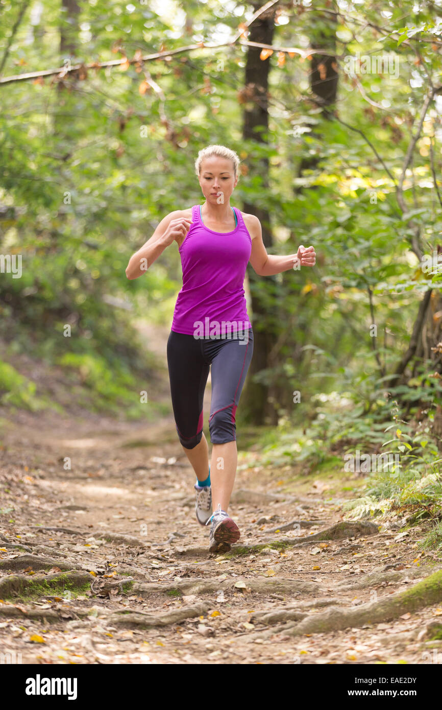 Pretty young girl runner in the forest Stock Photo - Alamy