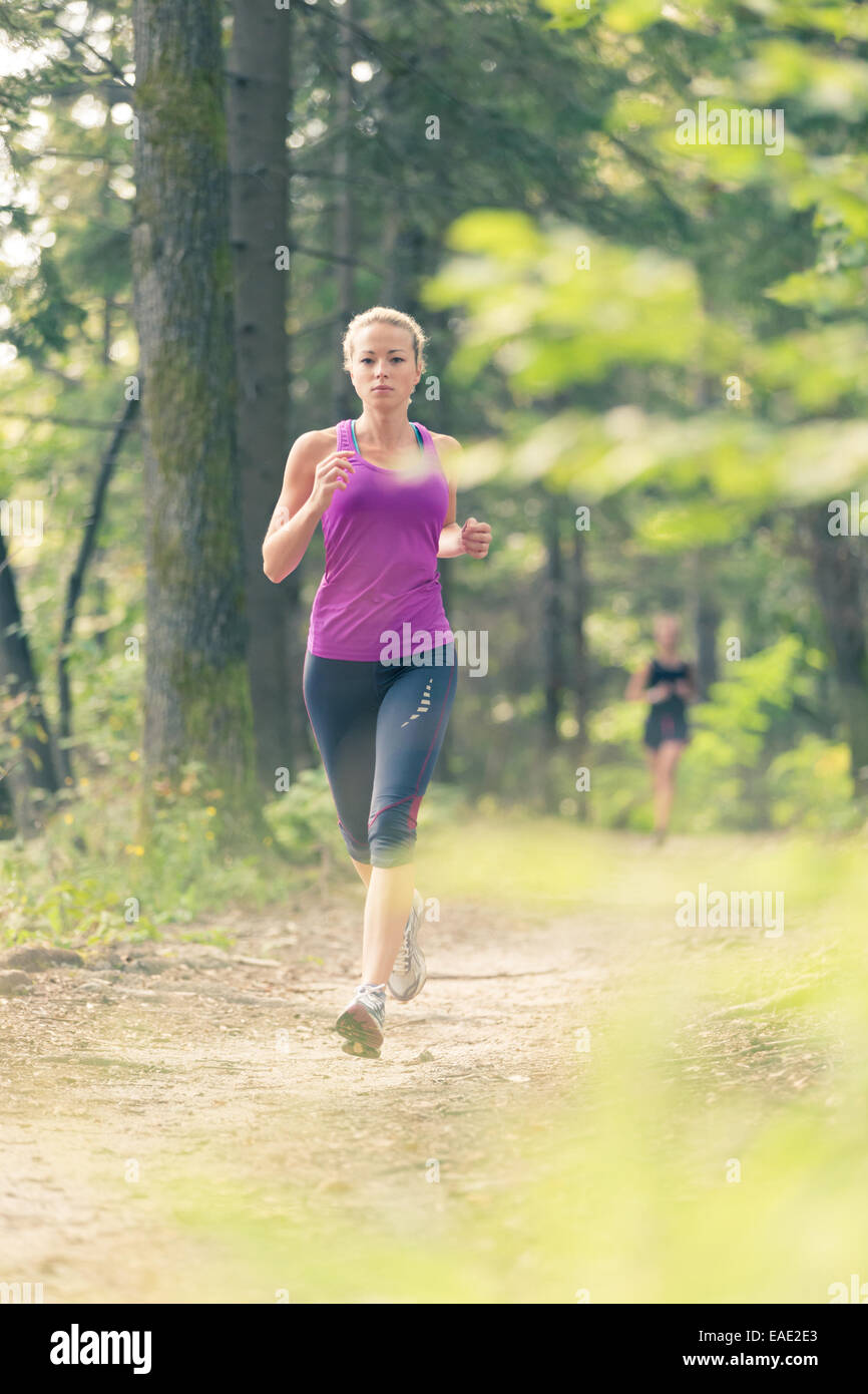 Pretty young girl runner in the forest Stock Photo - Alamy