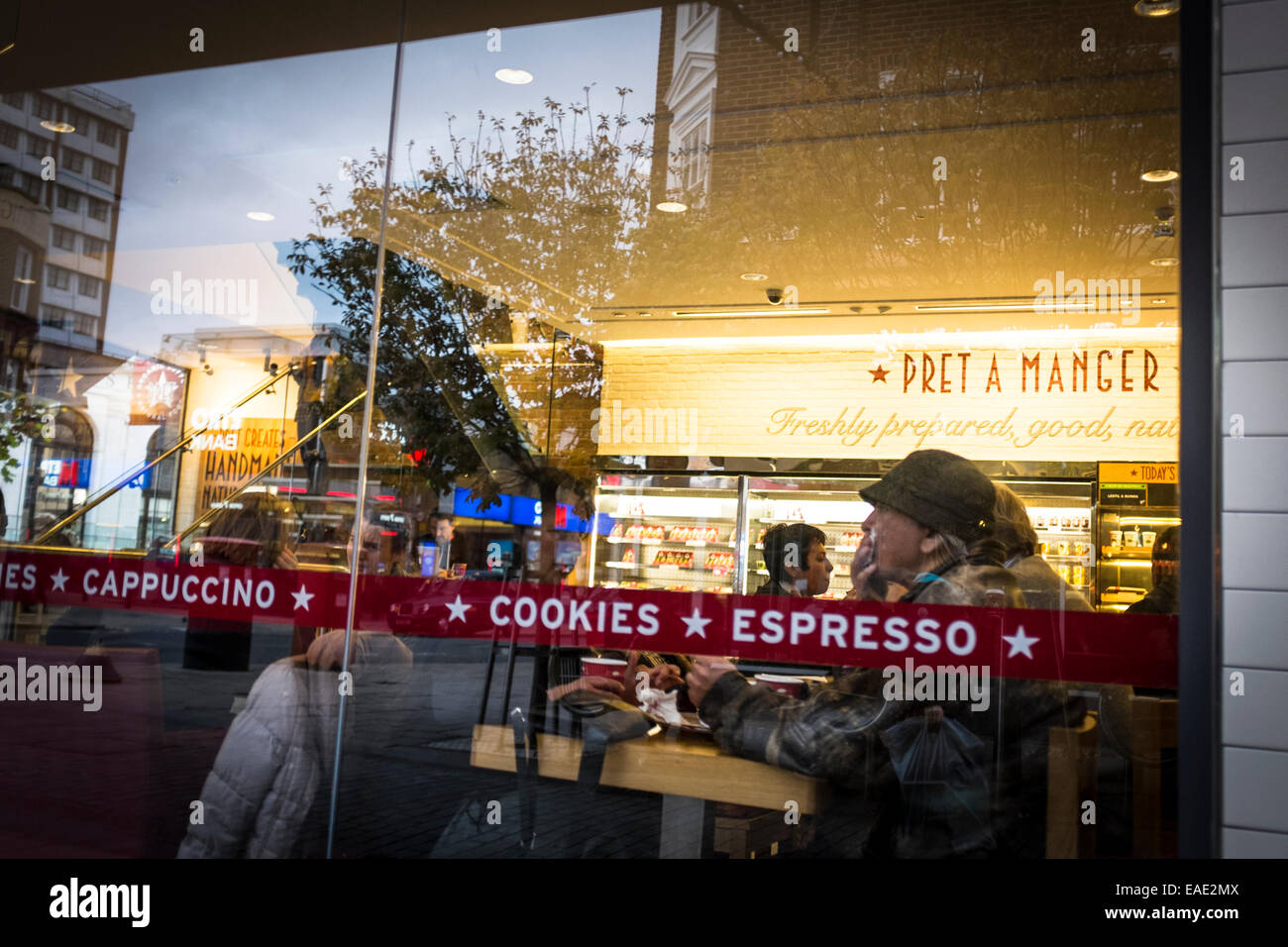 View of diners through the window of a fast food restaurant with ...
