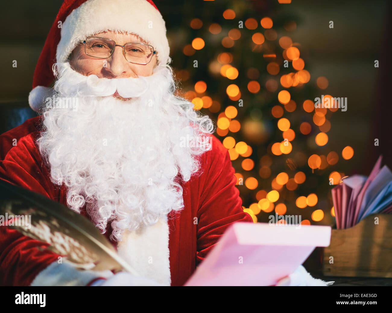 Portrait of Santa Claus reading and answering Christmas letters Stock ...