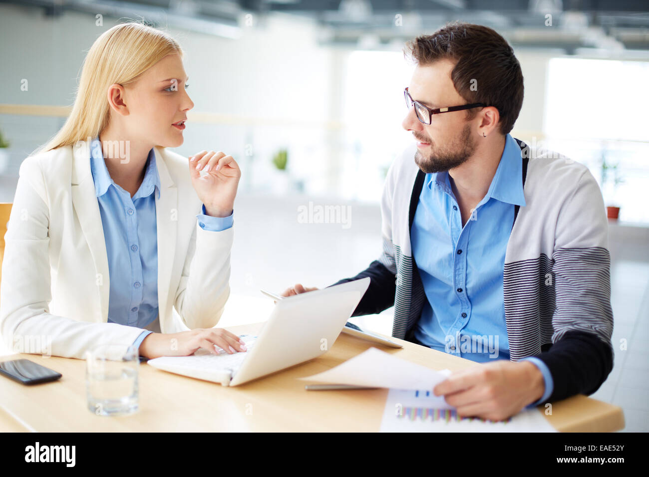 Two colleagues discussing ideas or project at meeting Stock Photo - Alamy